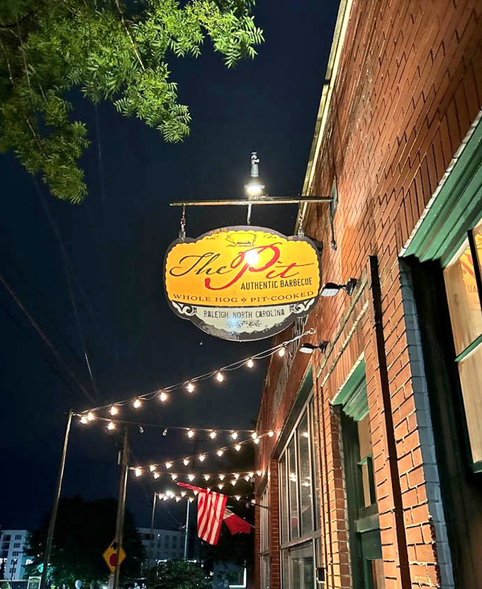 The Pit's sign glows like a North Star for barbecue pilgrims, especially magical against the night sky when hunger strikes hardest.