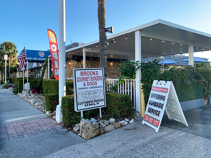The sign proudly announces "Brooks Gourmet Burgers & Dogs," a straightforward promise they deliver on with every bite.