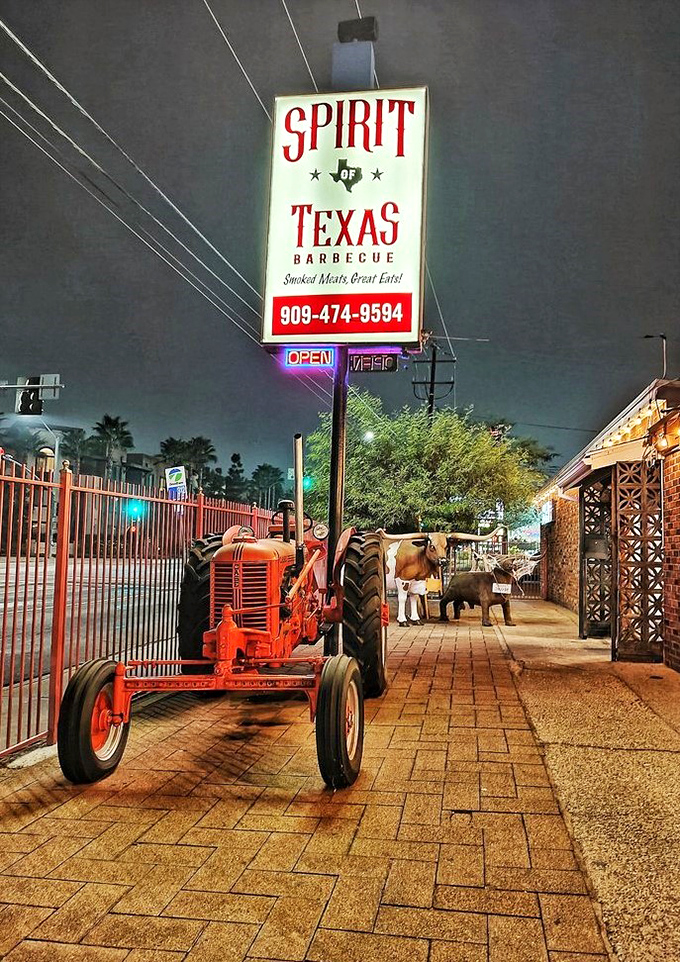Night falls but the Spirit of Texas shines bright, with that vintage tractor standing guard. Meat pilgrims welcome at all hours.