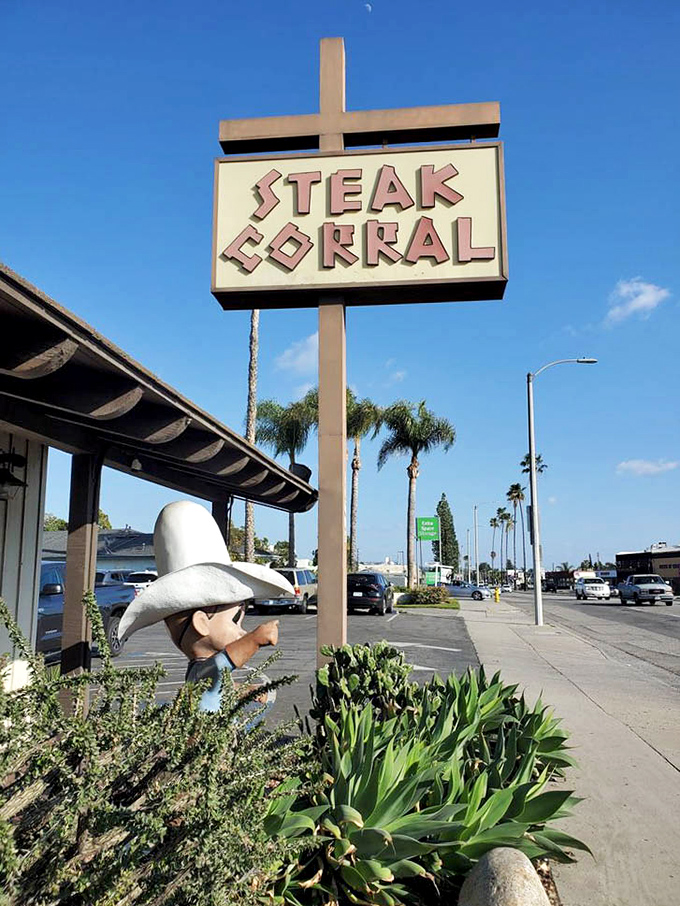 The Steak Corral sign against a perfect California blue sky. That cowboy silhouette has been welcoming hungry folks for generations.