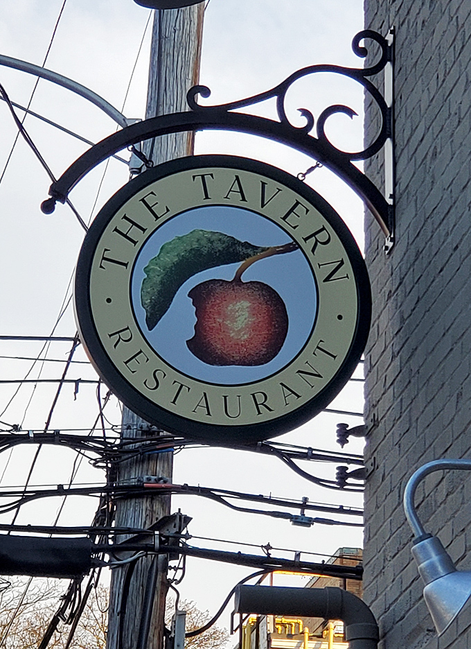 The Tavern's hanging sign features their signature cherry logo&mdash;a simple fruit that represents a complex and delicious dining experience.