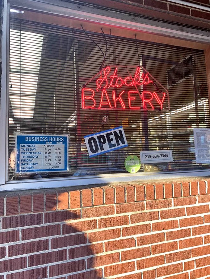 The neon "Stock's BAKERY" sign glows like a beacon for butter-loving souls. Those business hours are worth memorizing.