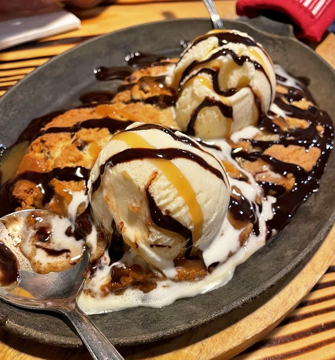 Dessert that arrives with a warning: "Caution, contents are irresistible." Ice cream melting into warm cookie creates a moment of pure bliss.
