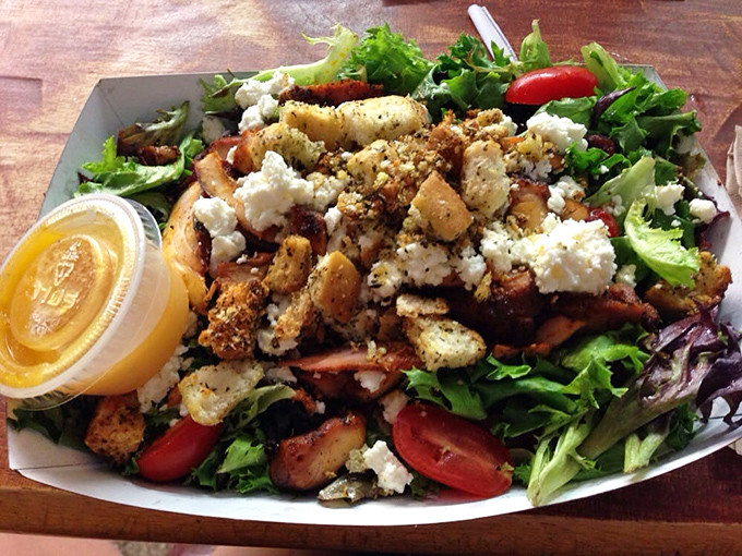 This smoked chicken salad showcases fresh greens, bacon, and hard-boiled eggs in a symphony of flavors.