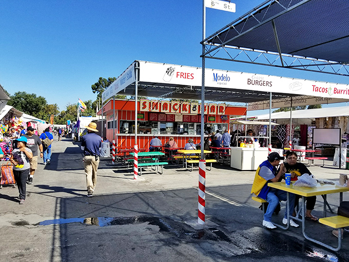 Snack time salvation at the food court, where shopping-induced hunger meets its match. These colorful picnic tables have witnessed countless deal celebrations.