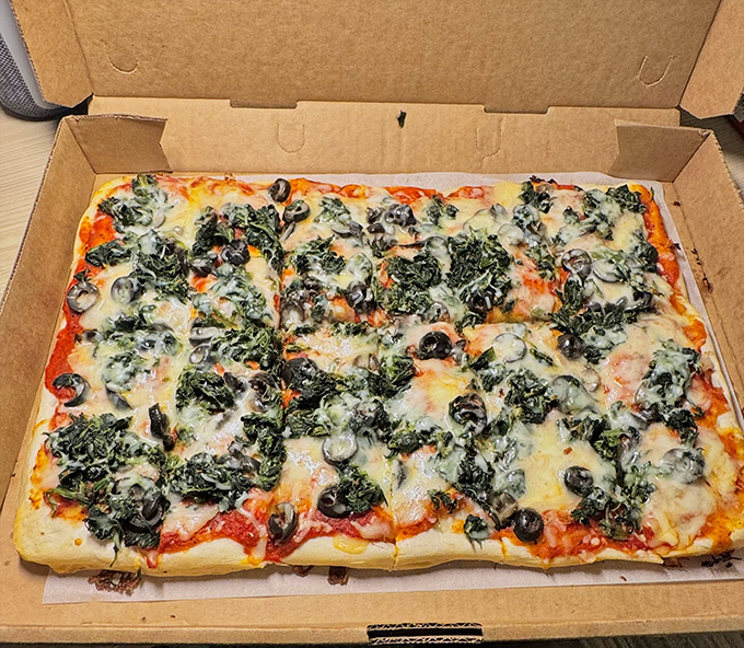 A rectangular masterpiece of spinach, cheese, and olives that defies pizza conventions. Old Forge style isn't round, and after trying this, you'll wonder why anyone bothers with circles.