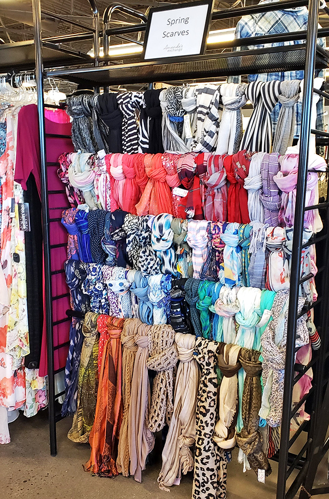 Scarves arranged like a textile rainbow, each one promising to be the magic accessory that pulls together outfits you've given up on.