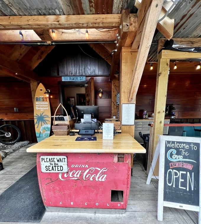 The host stand cleverly repurposes a vintage Coca-Cola cooler, combining Midwestern practicality with the universal truth that waiting is easier with nostalgic charm.