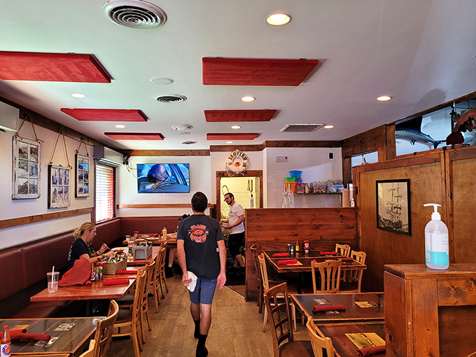 The dining room's warm wood tones and distinctive red ceiling panels create the perfect backdrop for seafood memories. Casual elegance at its finest.
