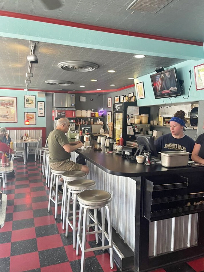 At the counter, where regulars perch like birds on a wire, the rhythm of diner life unfolds in a familiar dance.