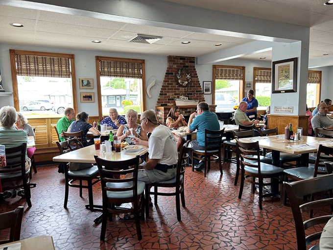 A bustling dining room where conversations flow as freely as the sweet tea. The wood-paneled walls have absorbed decades of seafood satisfaction.