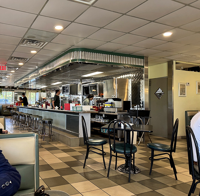 Where diner magic happens&mdash;the open kitchen where cooks transform simple ingredients into the comfort food that keeps us coming back.