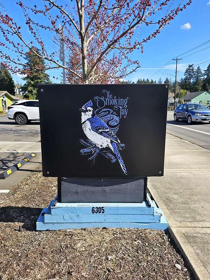 The blue jay logo stands sentinel at the roadside, a beacon of hope for the hungry and a warning to lesser barbecue joints.