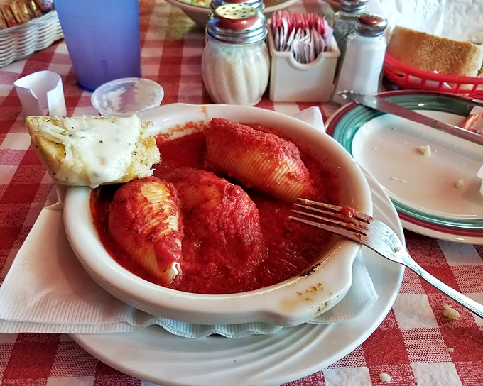 Stuffed shells that look like they're trying to escape their marinara bath but are actually just showing off their generous proportions. Resistance is futile.
