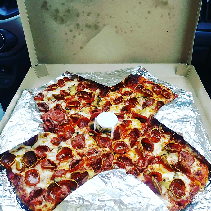 The take-home pizza box&mdash;a cardboard treasure chest containing tomorrow's breakfast that somehow tastes even better cold at 9 AM. 