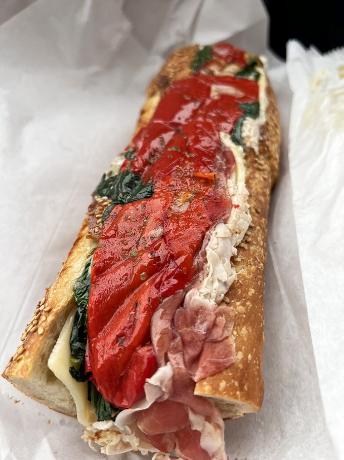 This sandwich isn't just food&mdash;it's architecture. Layers of meat, roasted red peppers, and greens create a color palette that's as beautiful as it is delicious.