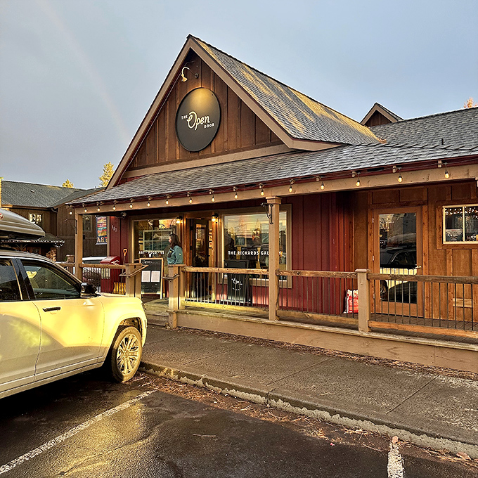 The Open Door's rustic-chic exterior catching golden hour light like it was designed for it. Those string lights aren't decoration&mdash;they're a promise of evening magic.
