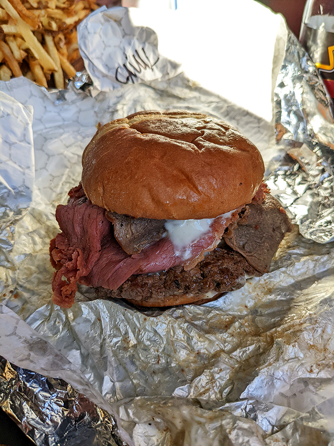 This triple meat burger doesn't mess around - it's a carnivore's dream that requires both hands and serious commitment.