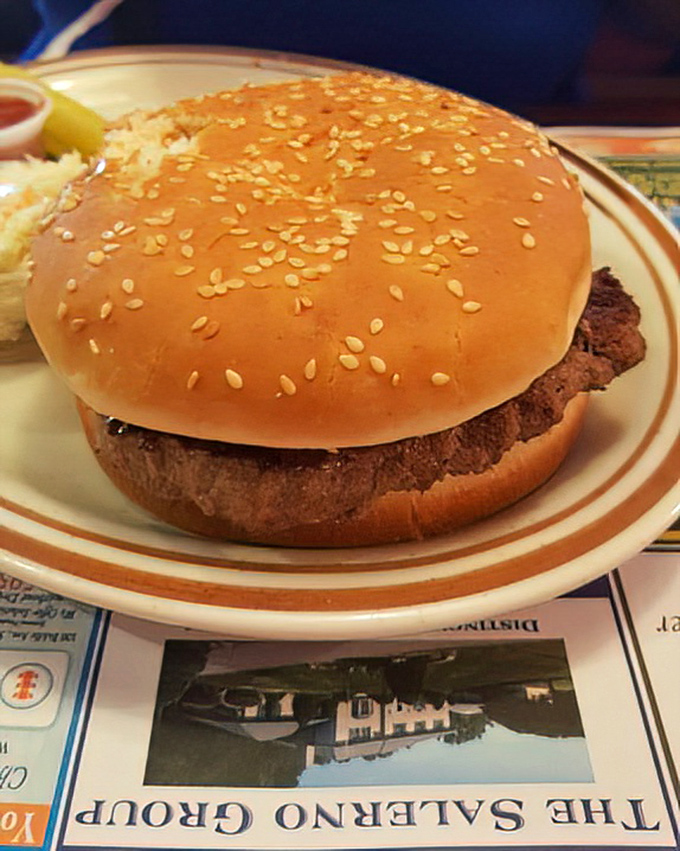 A burger so perfectly formed it looks like it should be in a food commercial, complete with a sesame seed bun wearing its seeds like tiny pearls.
