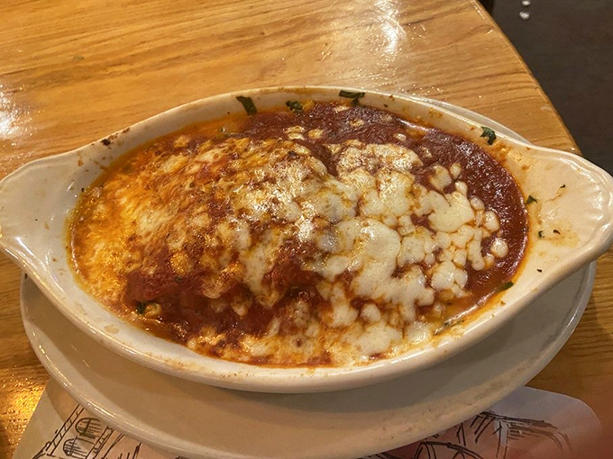 Bubbling cheese blanket tucked over layers of saucy goodness. The kind of dish that makes you want to hug the chef, then ask for the recipe.