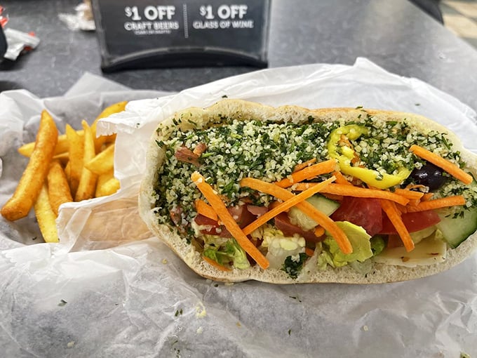 This pita pocket is stuffed fuller than your suitcase before a vacation, with vibrant veggies creating a portable garden party.