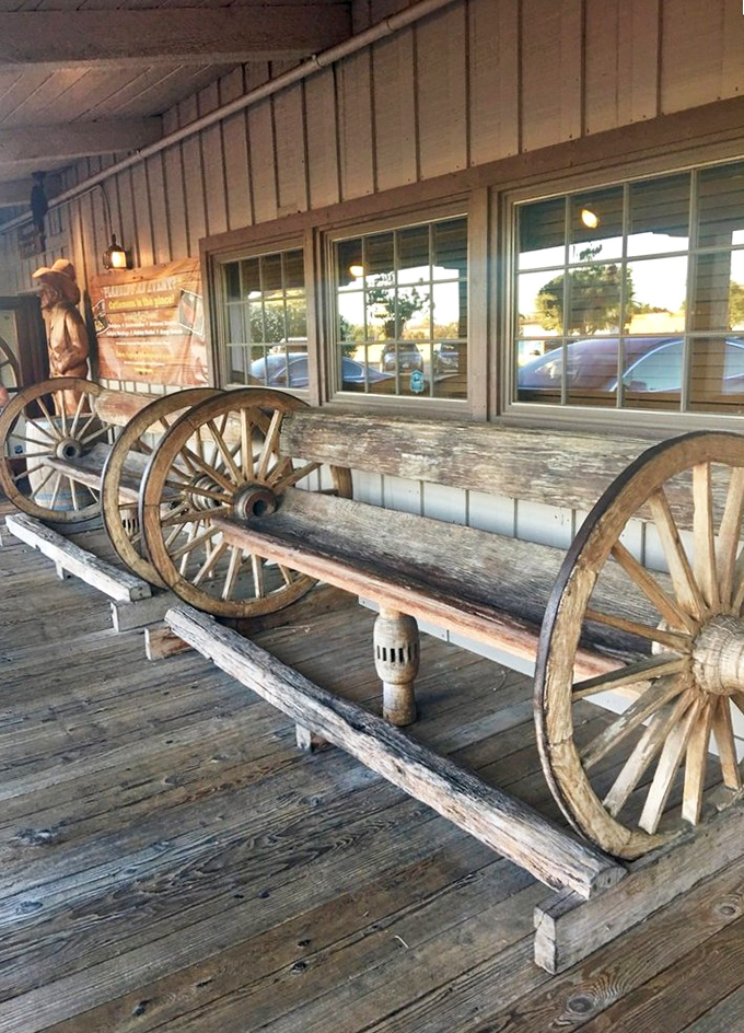 This wagon wheel bench isn't just for show&mdash;it's where hungry patrons contemplate life choices like "medium-rare or medium" while waiting.