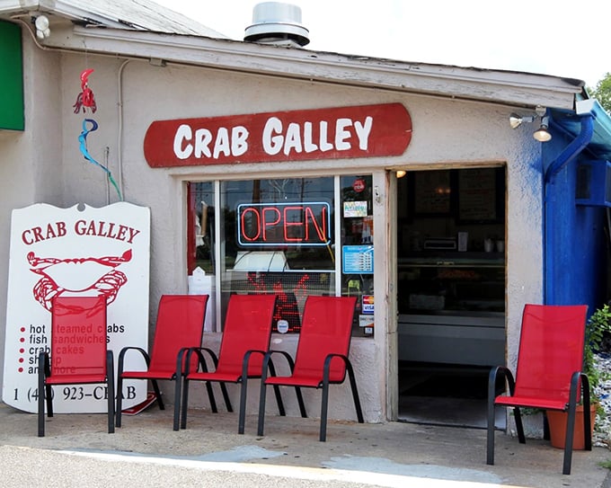 The red chairs aren't just seating&mdash;they're on-deck circles for the seafood major leagues. The sign promises treasures that Maryland does best.