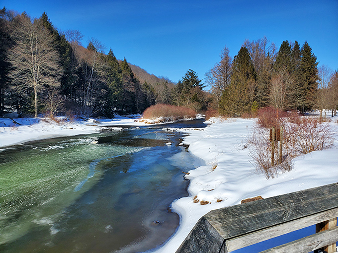 Winter transforms the landscape into a crystalline wonderland. The partially frozen river creates nature's most captivating modern art installation.