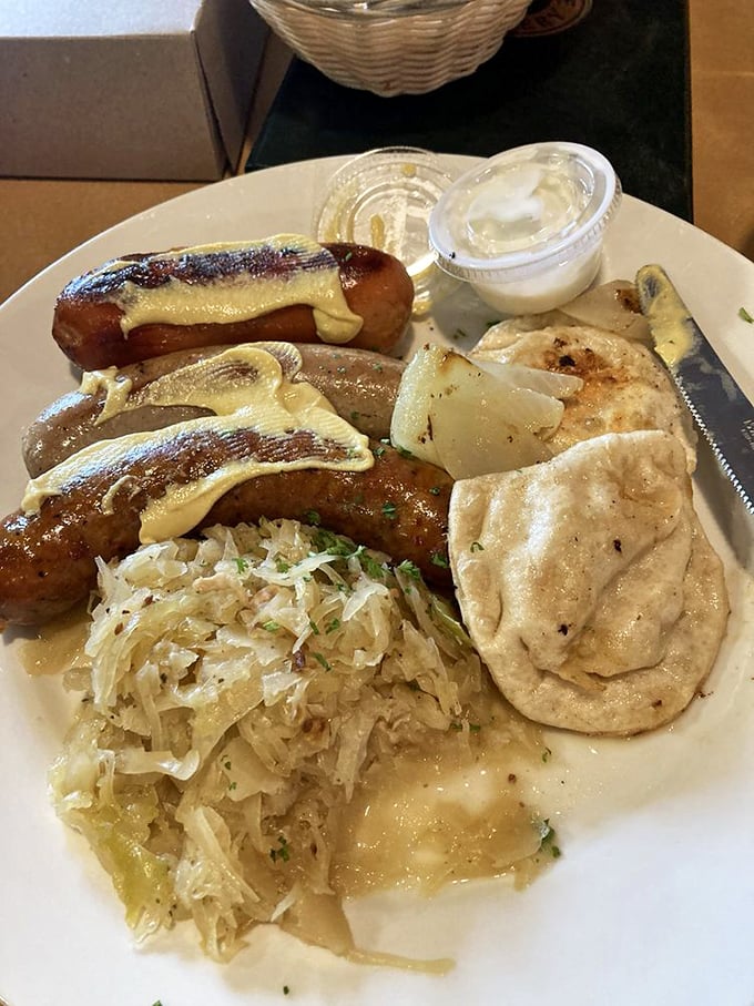 The wurst plate that's actually the best plate—succulent sausages nestled alongside sauerkraut and a dumpling that's begging to soak up all that savory goodness.