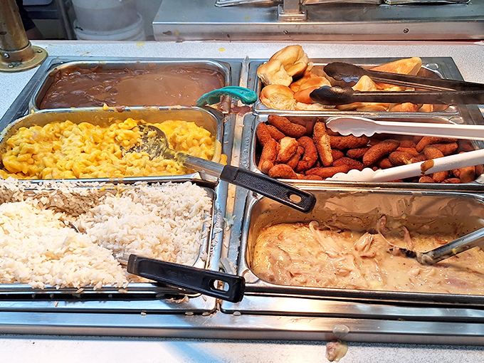 The buffet line&mdash;where decisions become impossible and "I'll just take a little of everything" becomes your mantra. Mac and cheese gleams with cheesy promise.