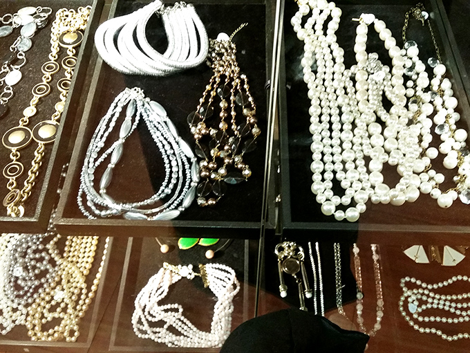 Pearl necklaces and vintage jewelry displayed like buried treasure. Coco Chanel would approve of these affordable accessories!