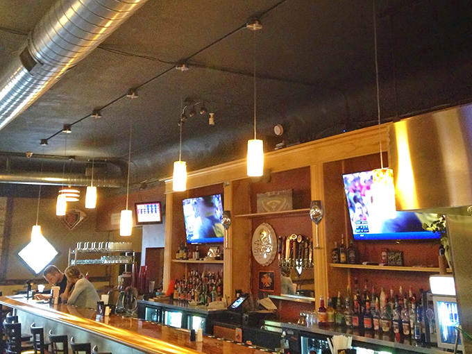 The bar where everybody might not know your name yet, but they'll remember your drink. Those pendant lights cast a glow that makes everyone look like they're on vacation.