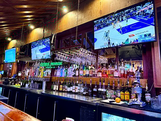 A bar stocked like an arsenal of liquid happiness, where sports play on screens and glasses hang like crystal stalactites.