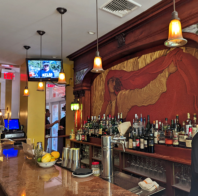 The bar at Le Virtù isn't just where drinks are made—it's where Italian hospitality comes alive. That mural watches over proceedings like a benevolent spirit.