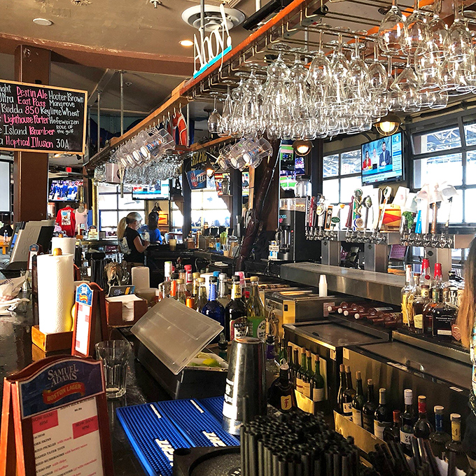 The bar at Dewey's—where locals swap fishing tales and visitors become regulars. Cold drinks and warm conversation flow equally freely here.