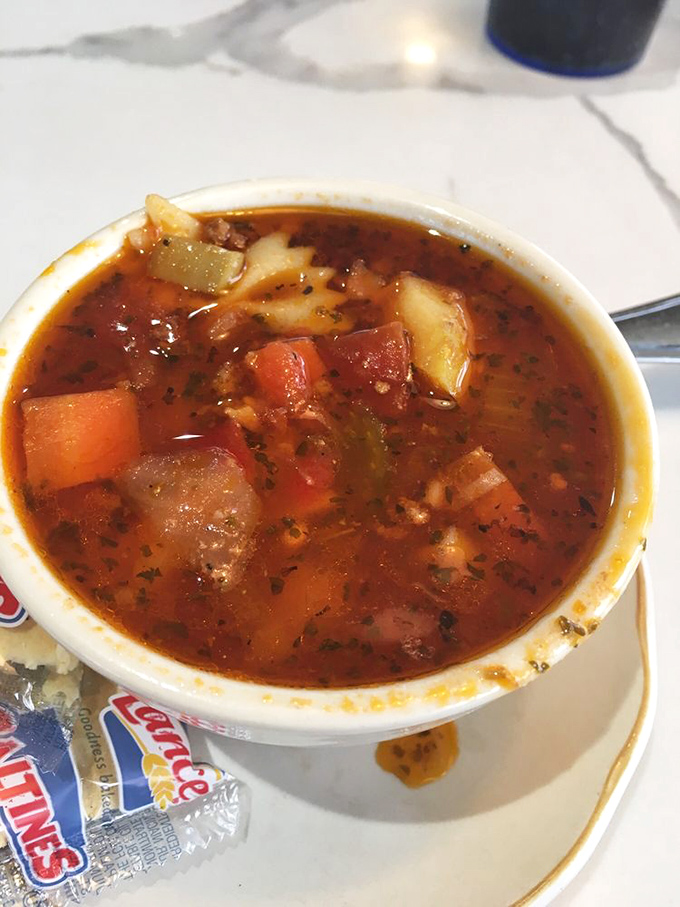 A hearty vegetable soup that looks like it could tell stories—each spoonful offering a different character in this liquid narrative.