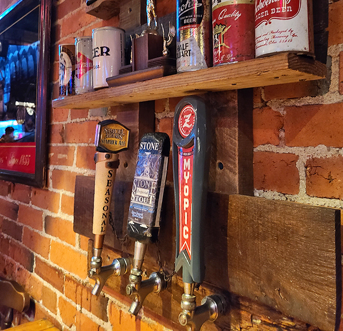 Craft beer taps mounted on exposed brick—because great pizza deserves great beer, and Hounddog's respects this sacred relationship.