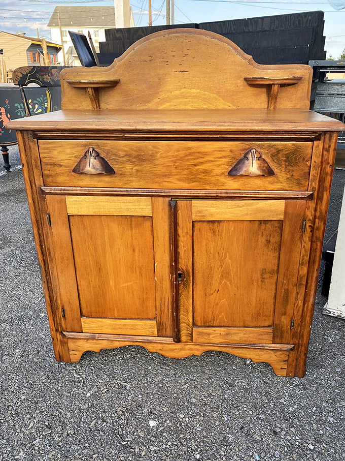 Antique cabinet with the kind of craftsmanship that makes modern furniture hang its head in shame. Wood that's survived longer than most marriages deserves respect.