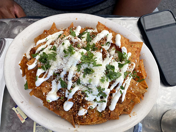 Chilaquiles: proof that breakfast knows no borders. This glorious mess of tortilla chips, sauce, cheese, and cilantro is the hangover cure we all deserve.