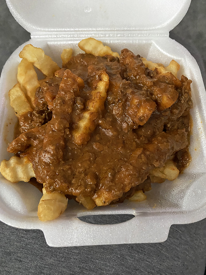 Crinkle-cut fries swimming in hearty chili &ndash; a fork-required indulgence that makes sharing nearly impossible. You've been warned.