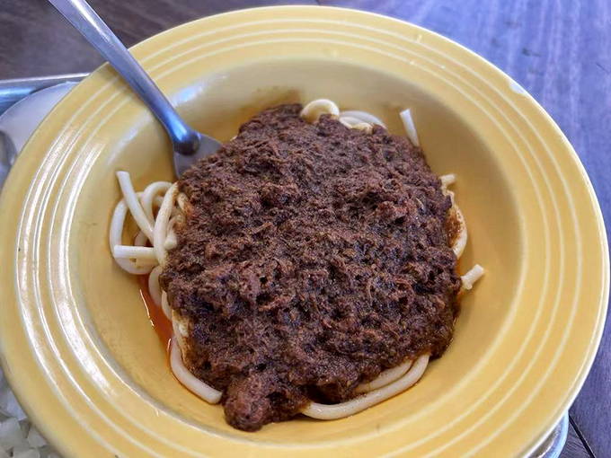 Chili spaghetti on a sunny yellow plate&mdash;a Midwestern classic that found its California home, proving comfort food knows no geographical boundaries.