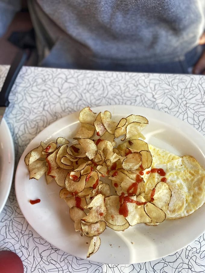 Homemade potato chips with a dash of hot sauce&mdash;proof that sometimes the simplest pleasures deliver the most profound satisfaction.