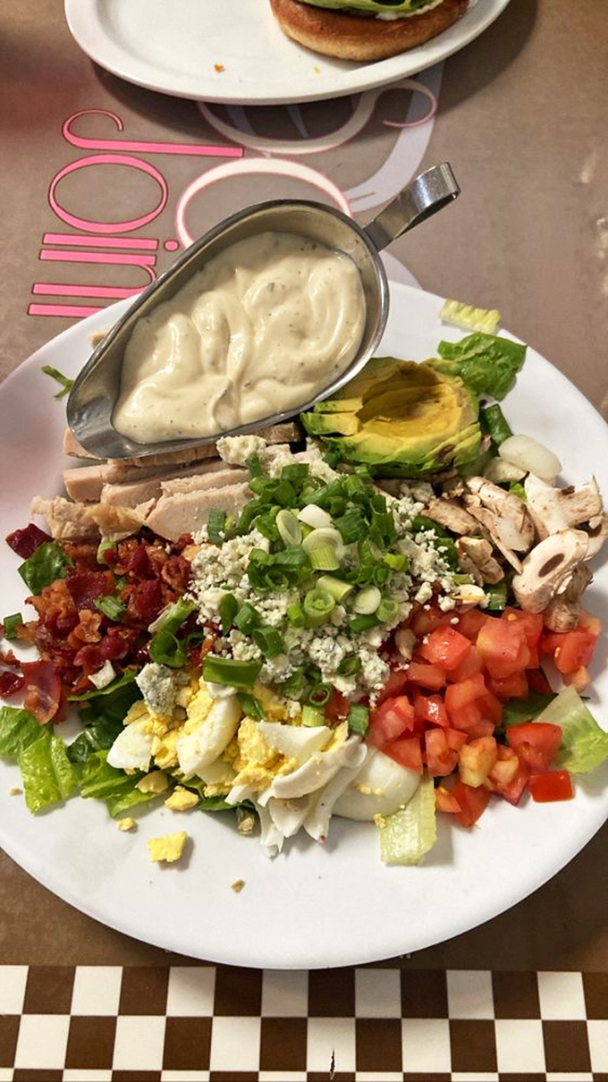 A Cobb salad that's practically a work of art &ndash; meticulously arranged ingredients waiting to be tossed into a symphony of flavors and textures.