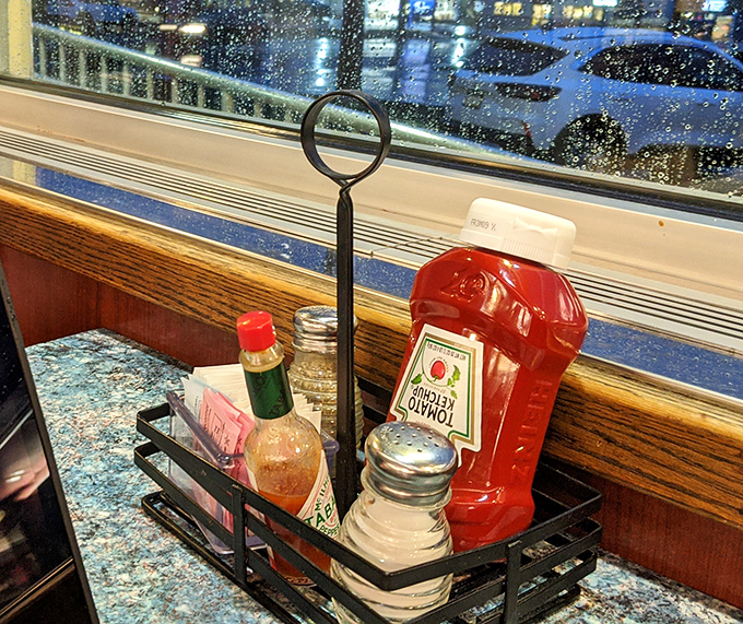 The condiment caddy&mdash;that miniature stage where ketchup, hot sauce, and sweetener packets perform their supporting roles in your dining experience.