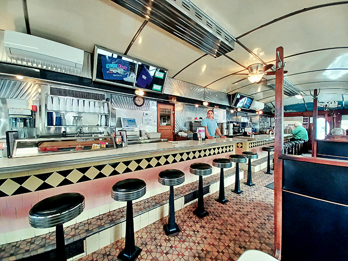 Stainless steel and checkered patterns create the backdrop for Virginia's morning symphony of sizzling, chatting, and coffee pouring.