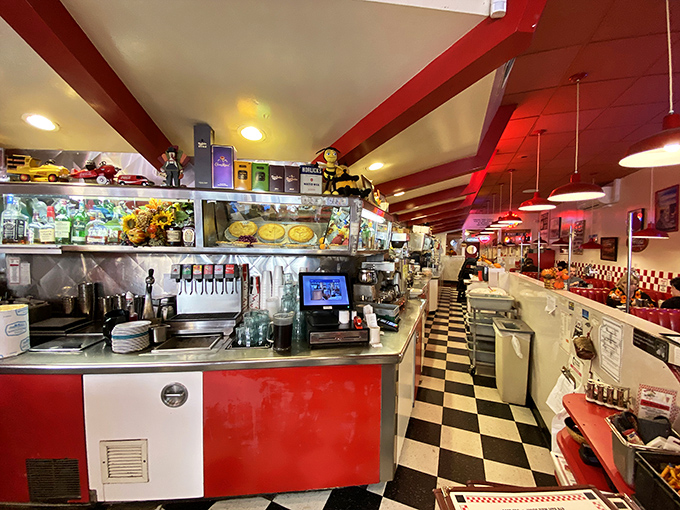 The counter and soda fountain stand ready for service, a command center of culinary nostalgia where milkshakes are born and coffee cups never empty.
