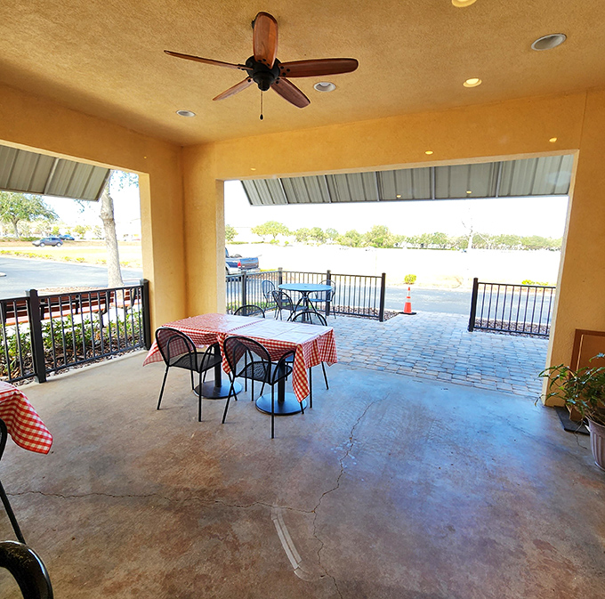 The covered patio with classic red-checkered tablecloths – where fresh air and smoky aromas create the perfect Florida dining experience.