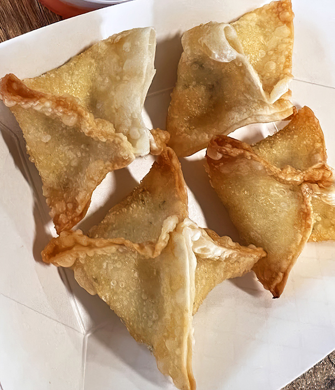 Golden crab rangoon triangles provide the perfect creamy, crispy contrast to spicy Korean main dishes.
