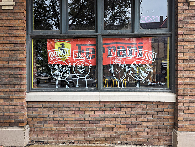 Window art declares "Donut Mess With Cleveland," capturing the playful pride that makes this shop more than just a place to eat.