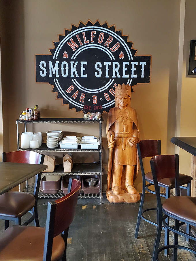 Where tradition meets whimsy. The carved wooden figure standing sentinel beside the Smoke Street logo adds unexpected character to this barbecue haven.